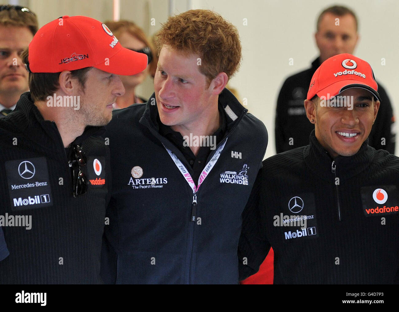 Prince Harry talks with McLaren Mercedes drivers Jenson Button and ...
