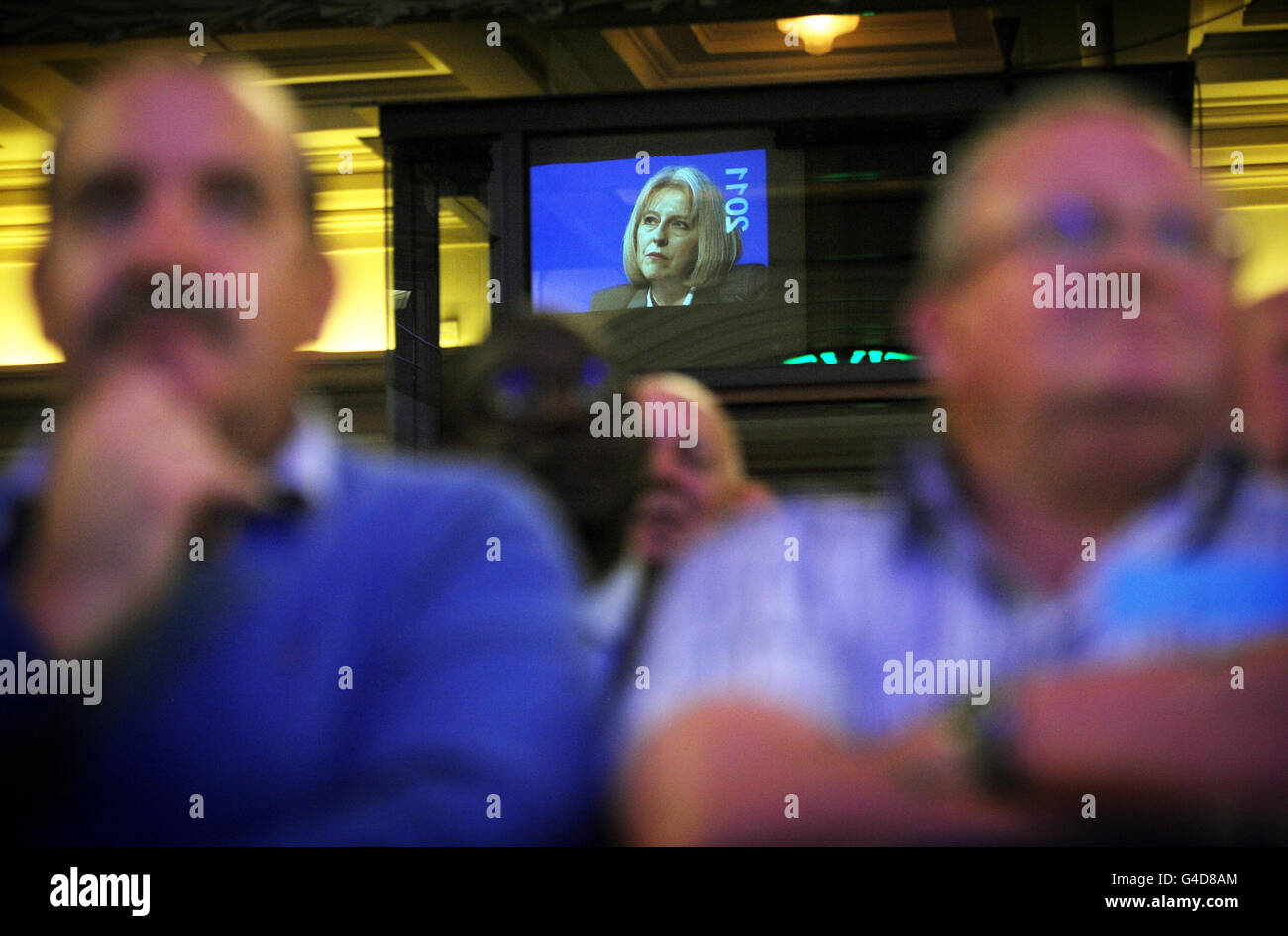 Police officers watch a video of Home Secretary Theresa May speaking at ...