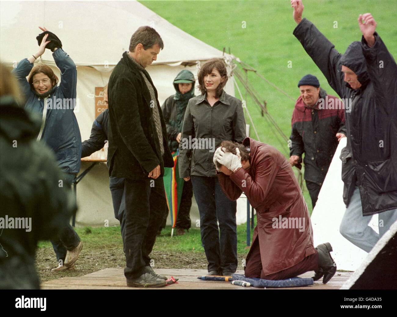 Actors Pierce Brosnan (left, standing) and Richard E Grant (kneeling ...