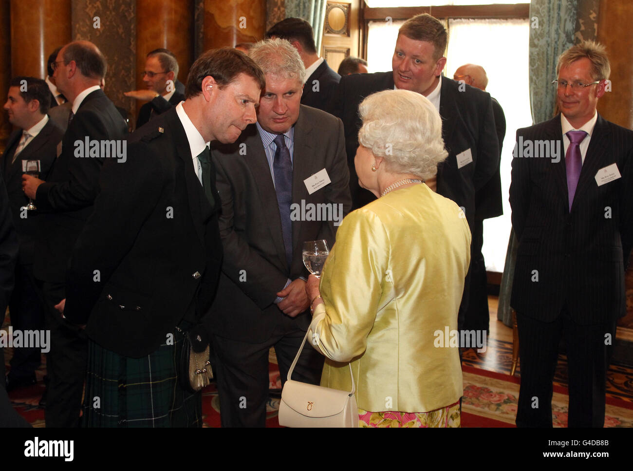 Britain's Queen Elizabeth II meets Eric Hawthorn (left) and Paul Trigg ...