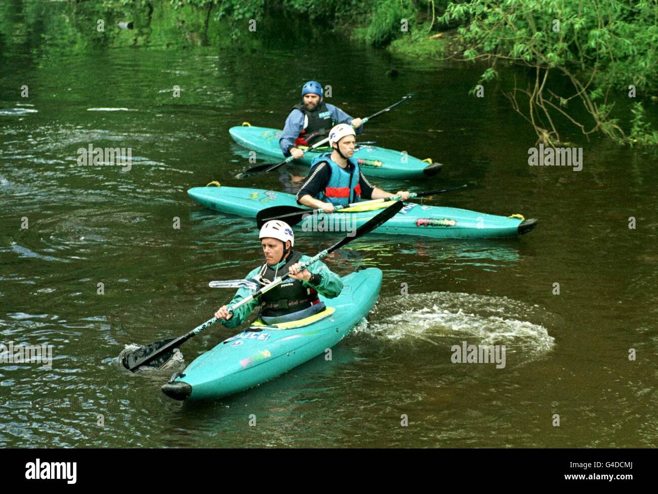 Police officers scower the banks of the river Dane using canoes today ...