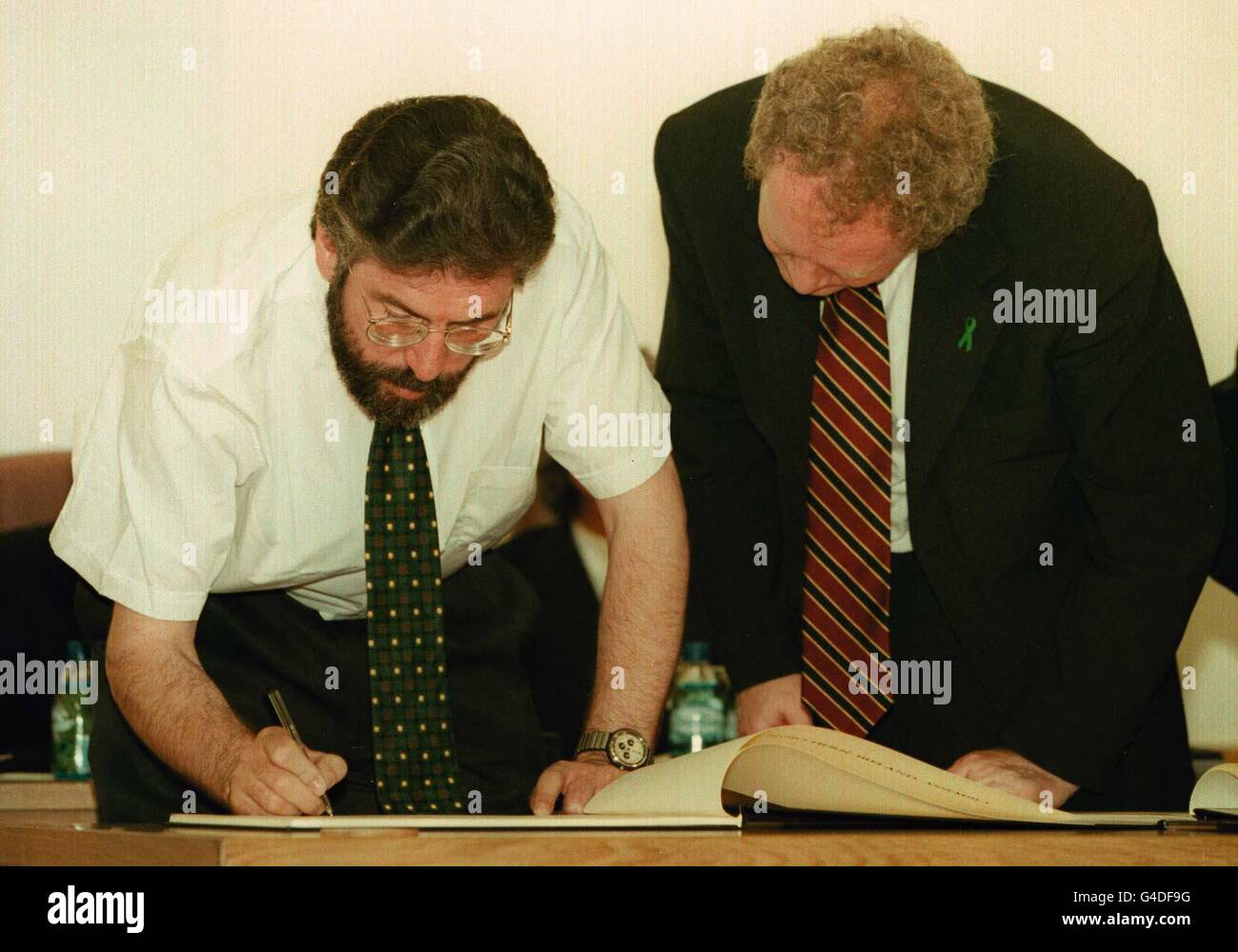 Sinn Fein President, Gerry Adams (left) and Martin McGuinness sign the ...