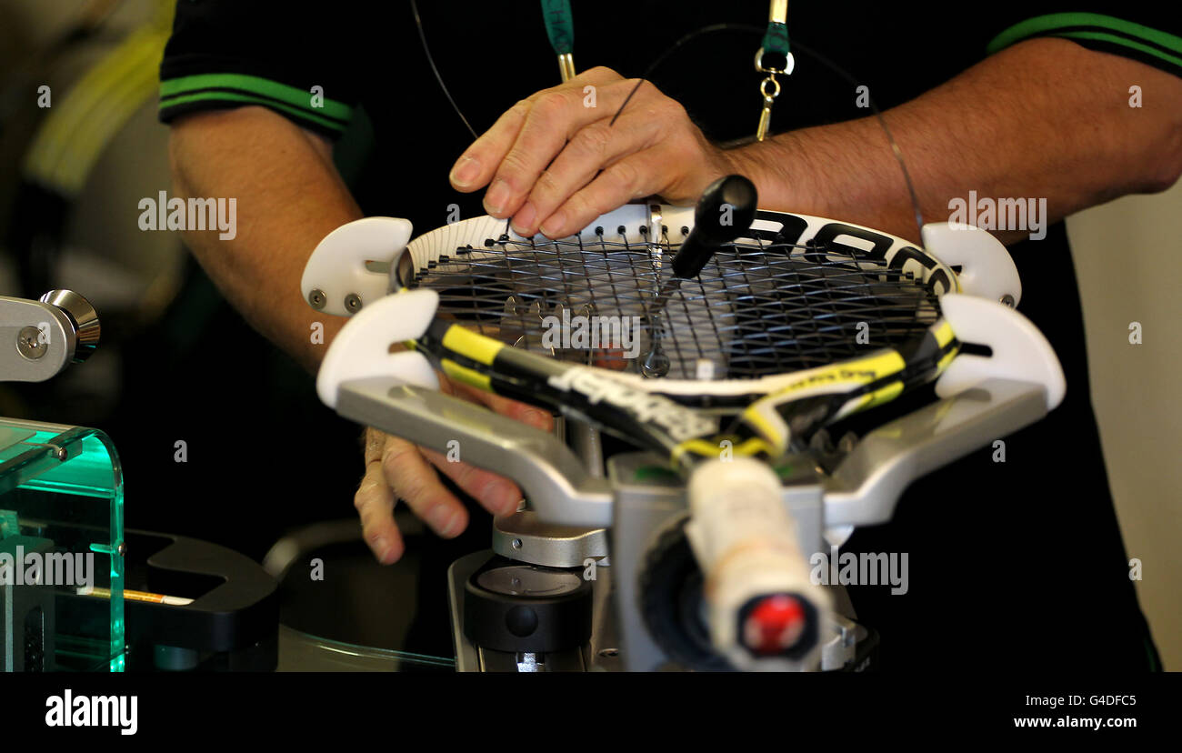 Head Racket Stringer Roger Dalton strings the racket of Spain's Rafael ...