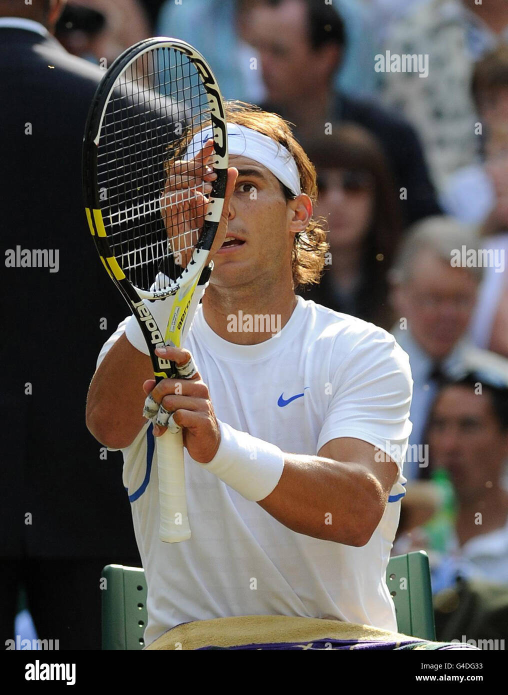 Spain's Rafael Nadal adjusts his racquet in his match against Great ...