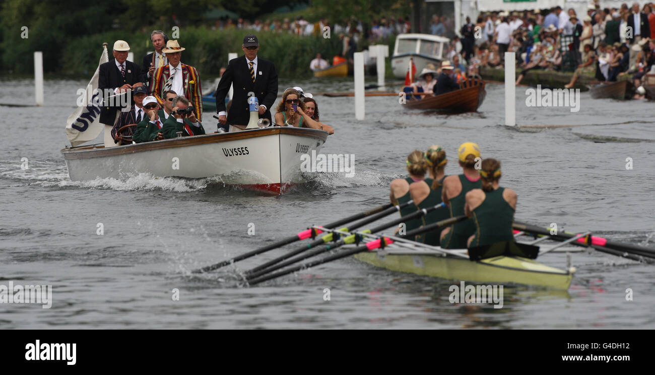 An officials launch boat watching the teams rowing and referee a race ...