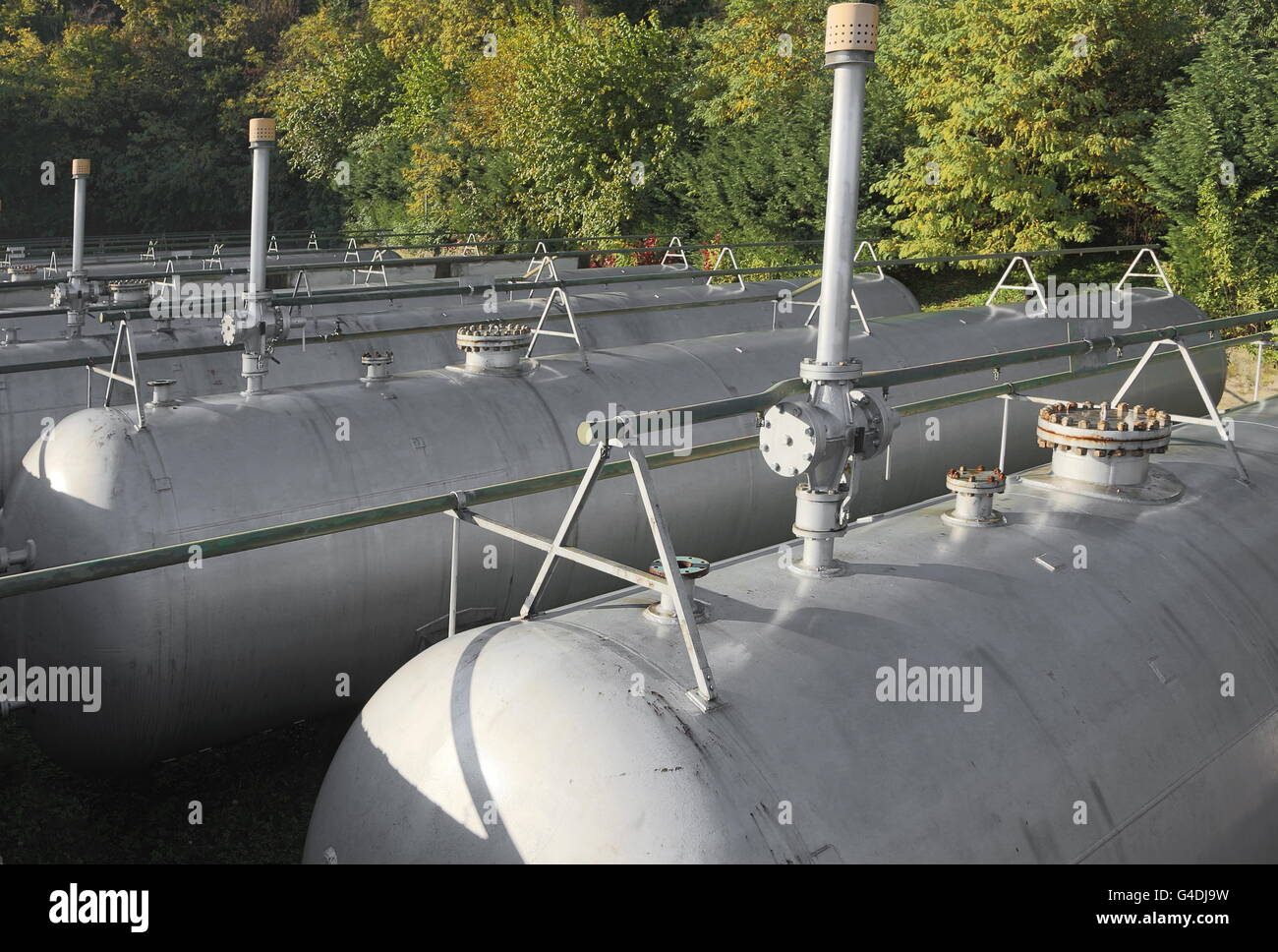 many giant tanks with venting valves and safety valve for the storage ...