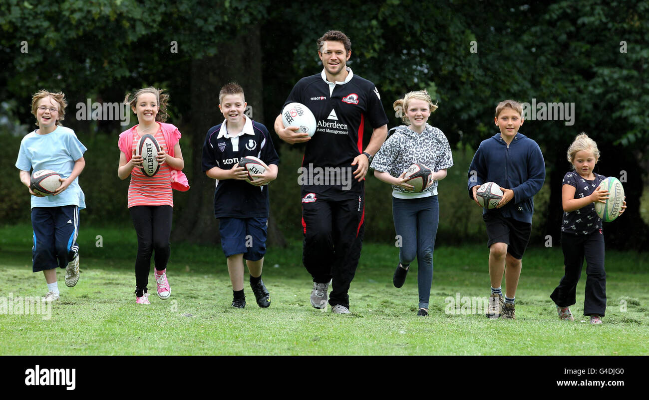 Edinburgh Rugby's Alan MacDonald poses for the media with children from ...