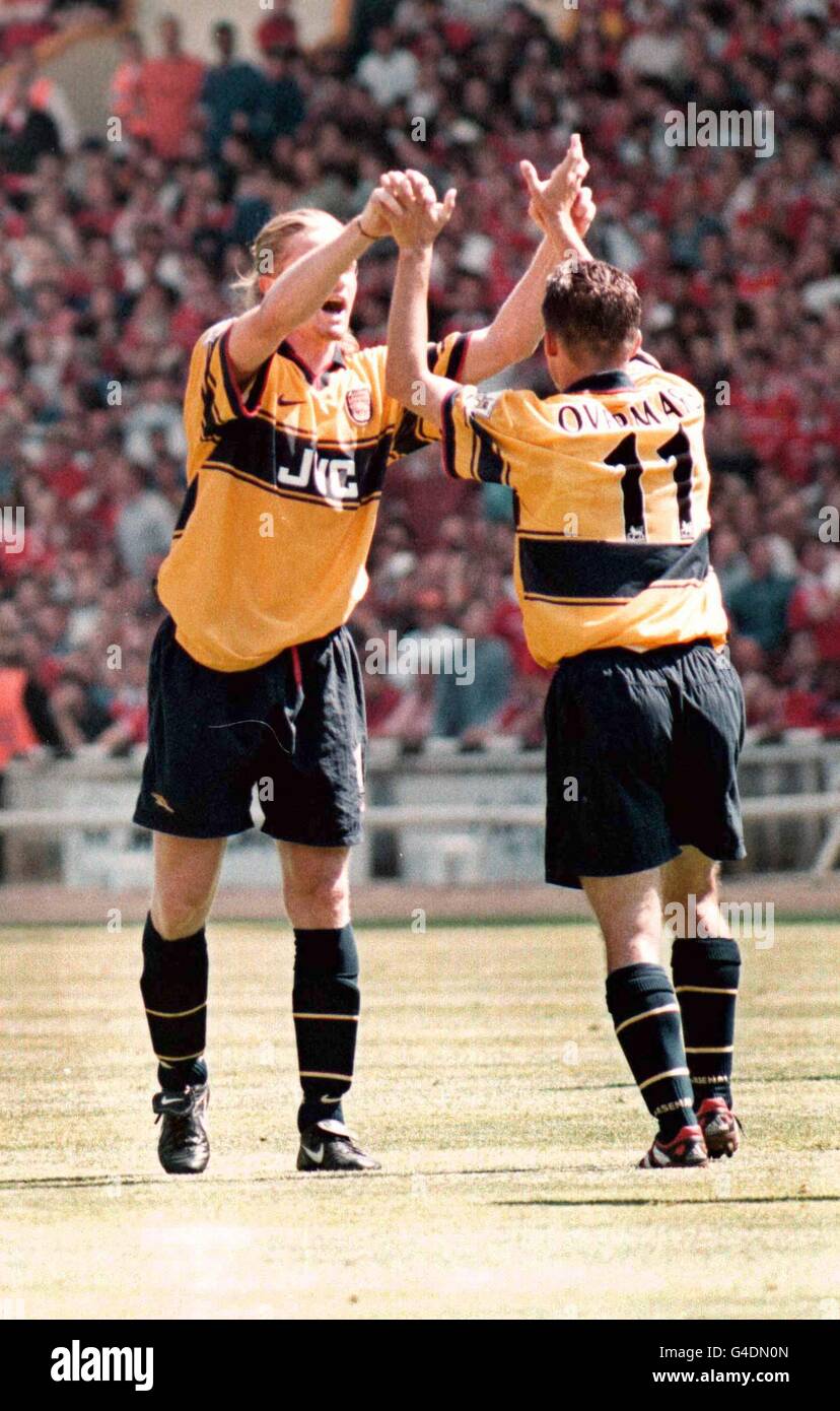 Arsenal's Emannuel Petit (left) congratulates Mark Overmars after he ...