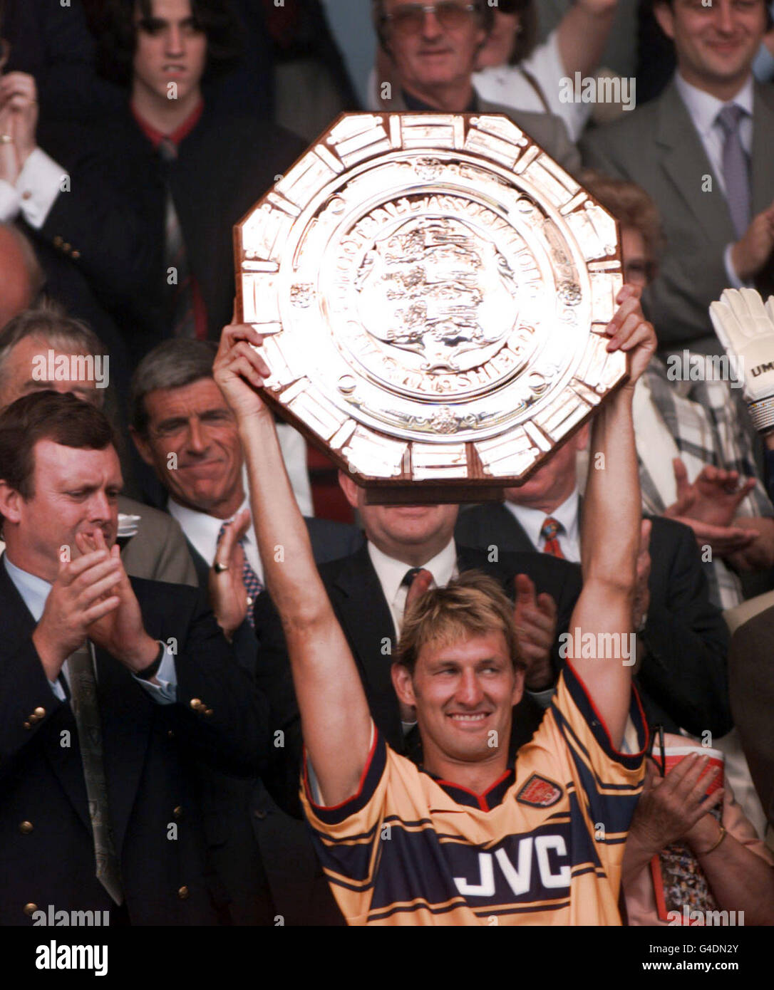 Arsenal captain Tony Adams holds aloft the Charity Shield trophy after ...