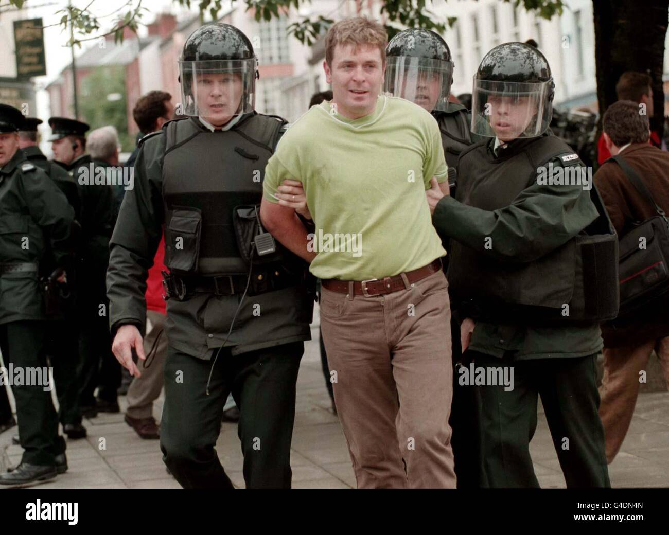 A loyalist protester is led away by RUC riot police after scuffles in ...