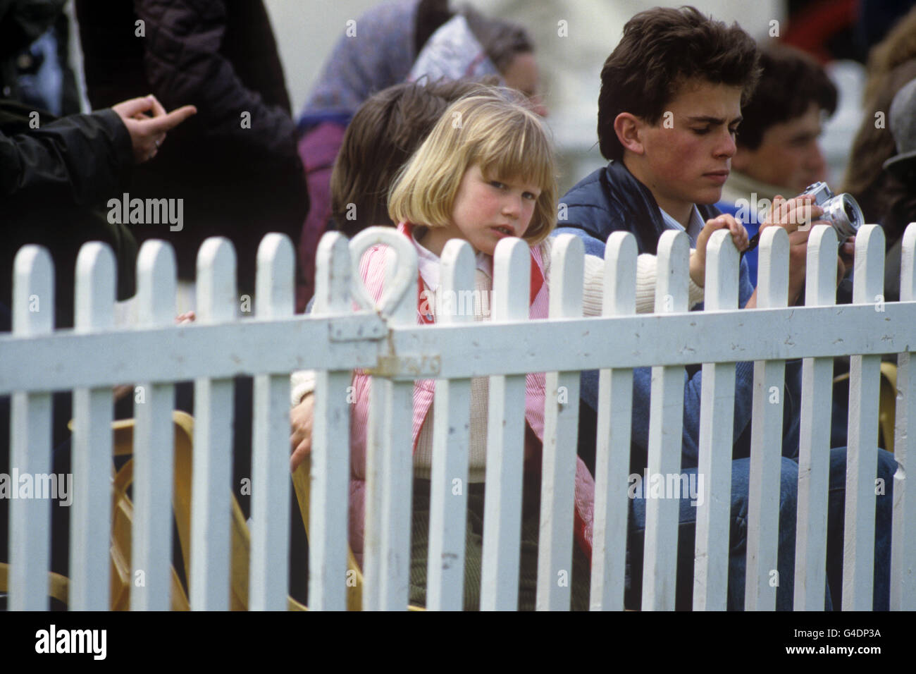 Zara Phillips, the daughter of Princess Anne, peers over a picket fence ...