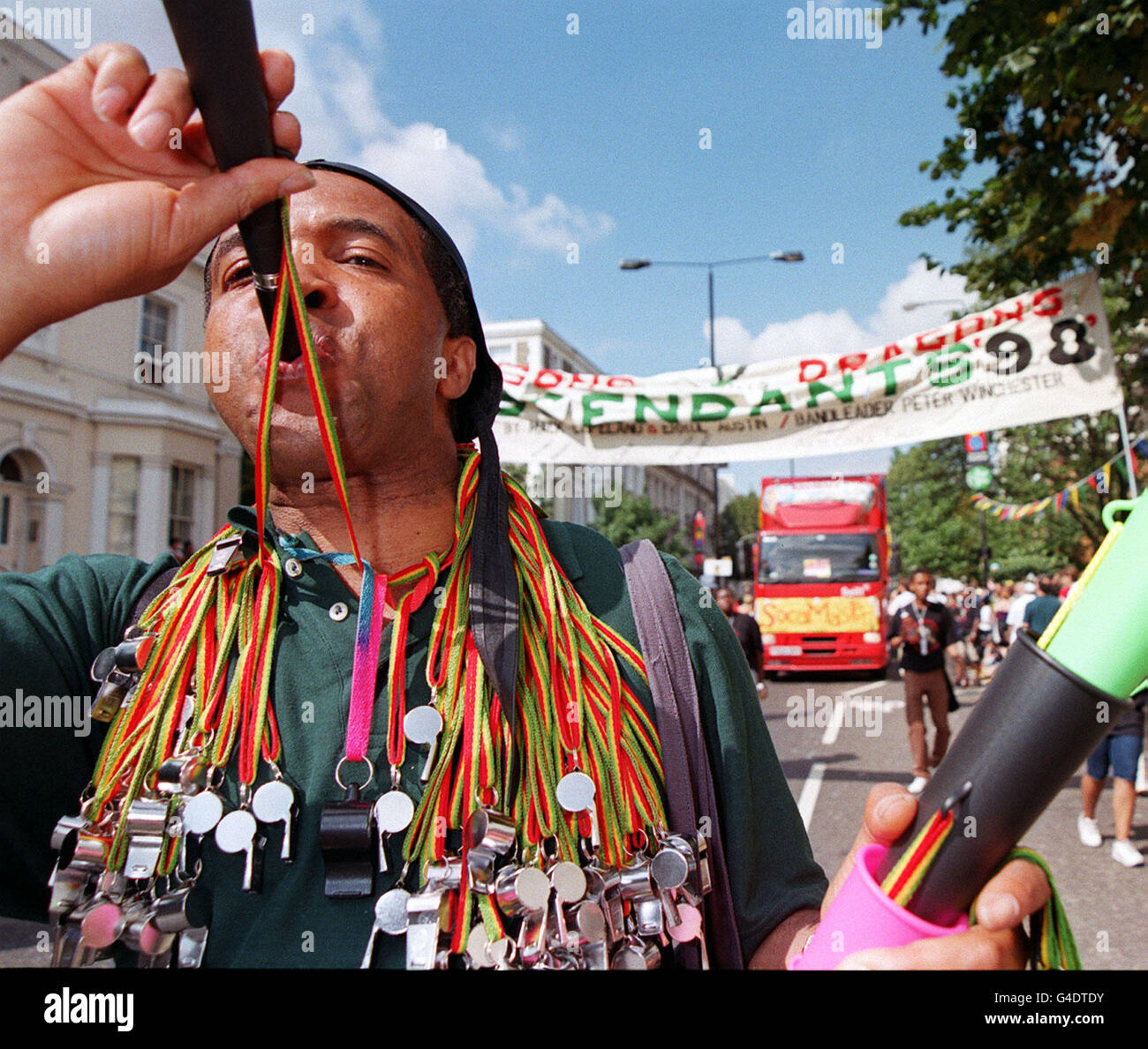 A whistle salesman joins the procession during the Notting Hill ...