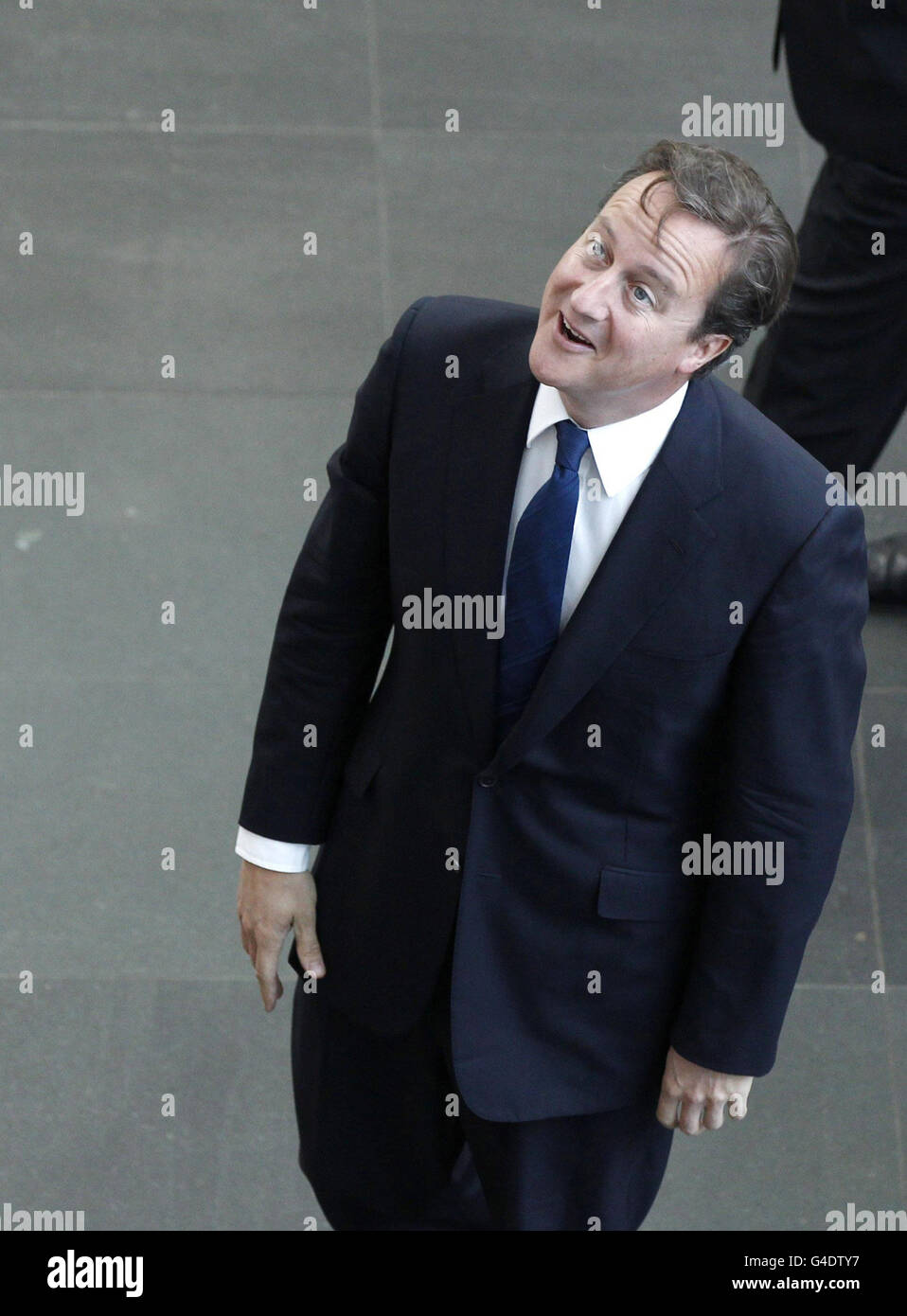Britain's Prime Minister David Cameron looks up at staff as he arrives ...