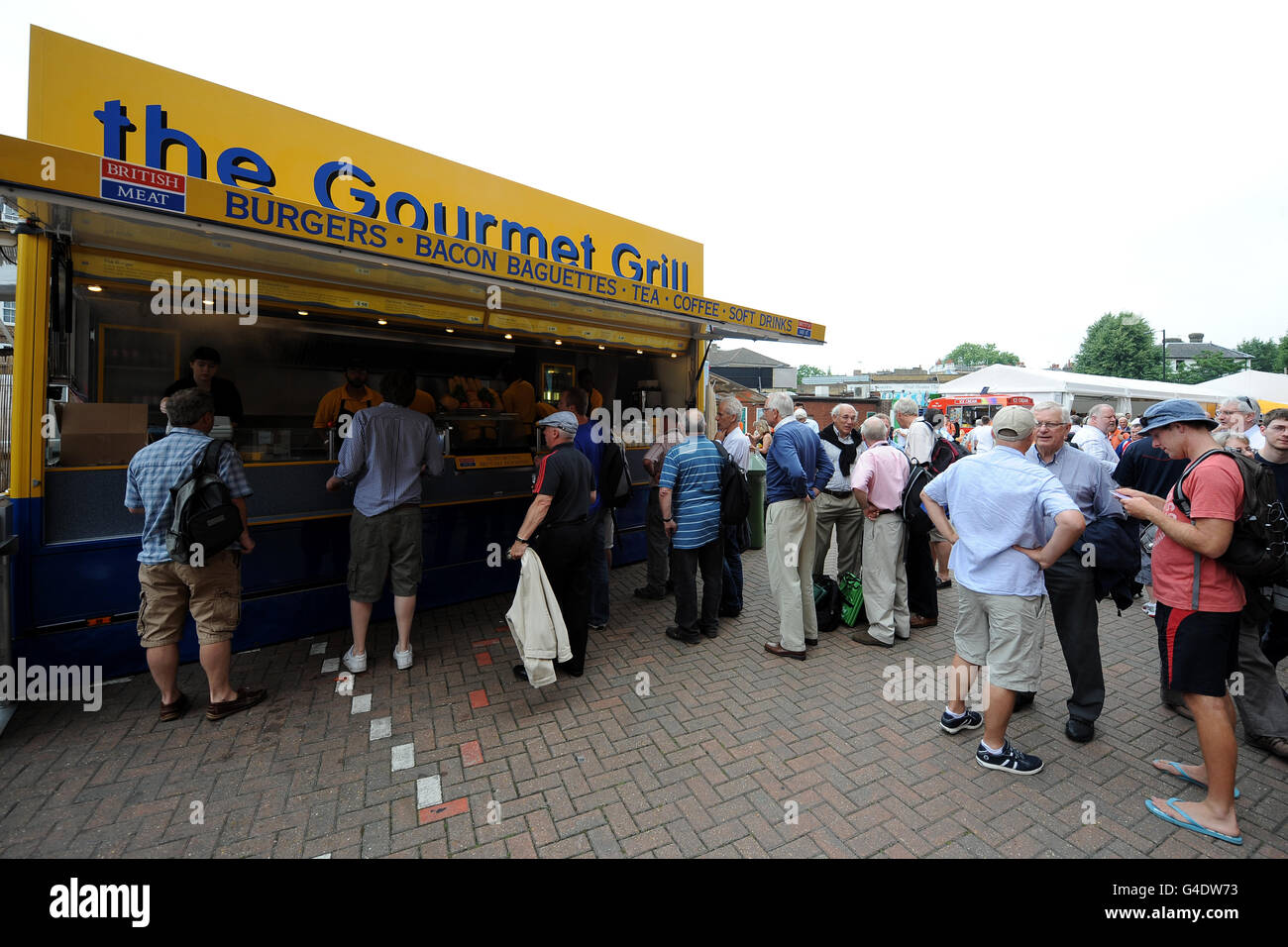 Fans queue up to buy food from the Gourmet Grill food concession Stock ...