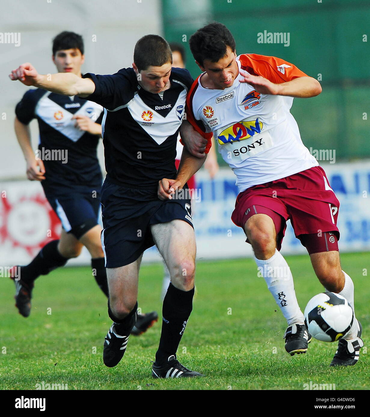 Melbourne Victory's Cameron Drake, left, with Queensland Roar player ...