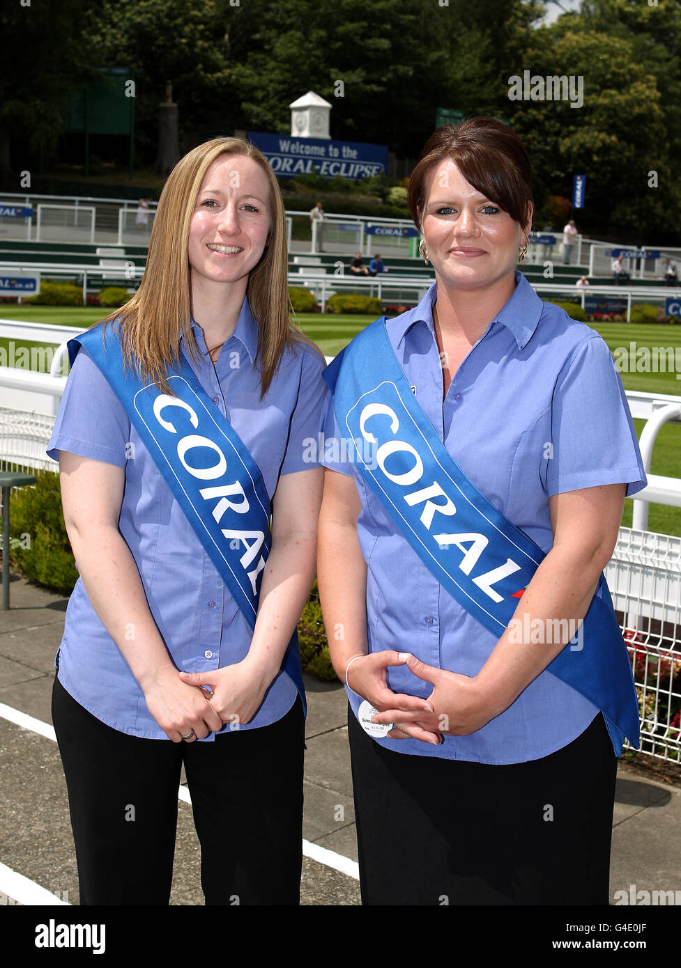 Coral staff pose for a photograph next to the parade ring Stock Photo ...