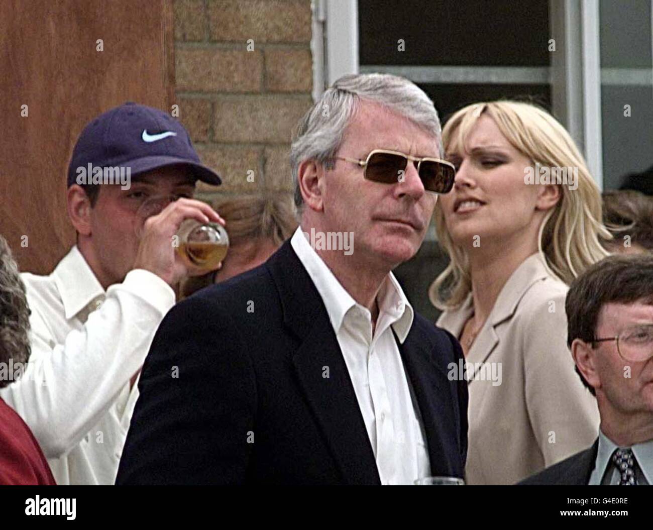 Former Prime Minister John Major (black jacket) with his son James ...