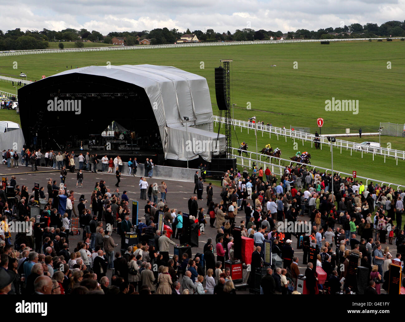 The field pass the Epsom Live stage in the home straight during The ...