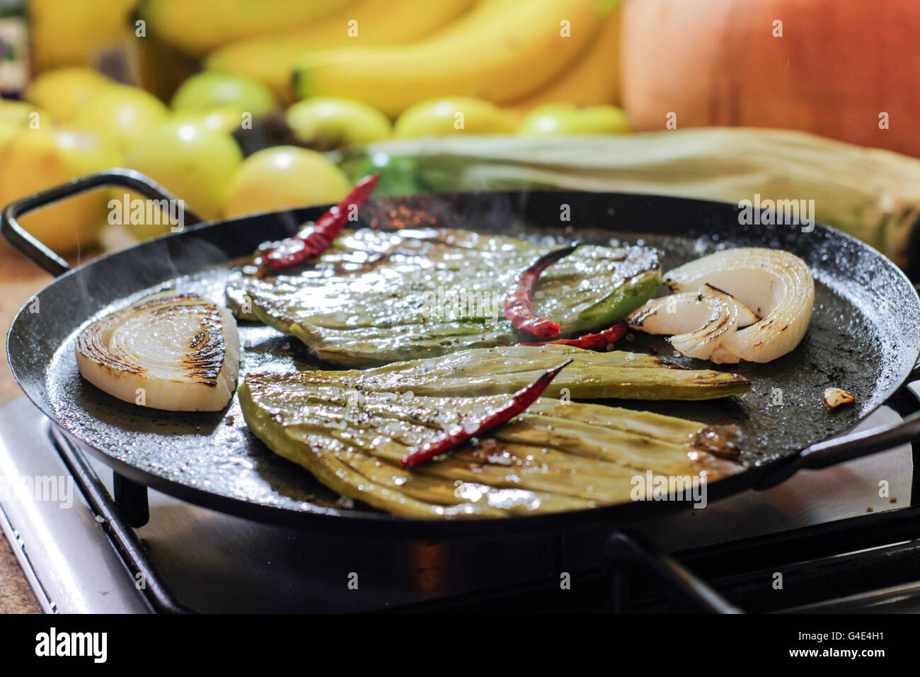 Photograph of some nopals on a hot pan on a stove Stock Photo - Alamy