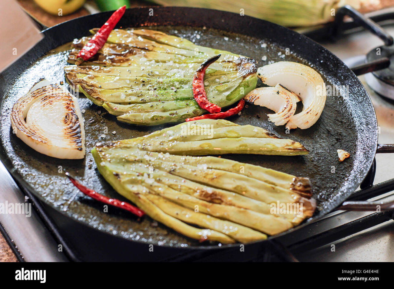 Photograph of some nopals on a hot pan on a stove Stock Photo - Alamy