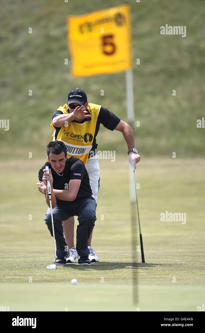 England's Adam Wootton lines up a putt with his caddy on the 5th green ...