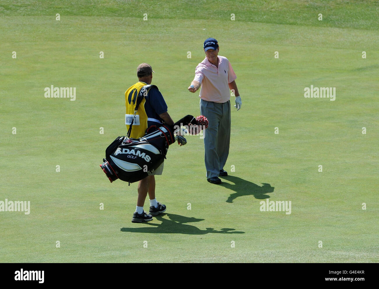 USA's Tom Watson hands his ball to his caddie after scoring a hole in ...