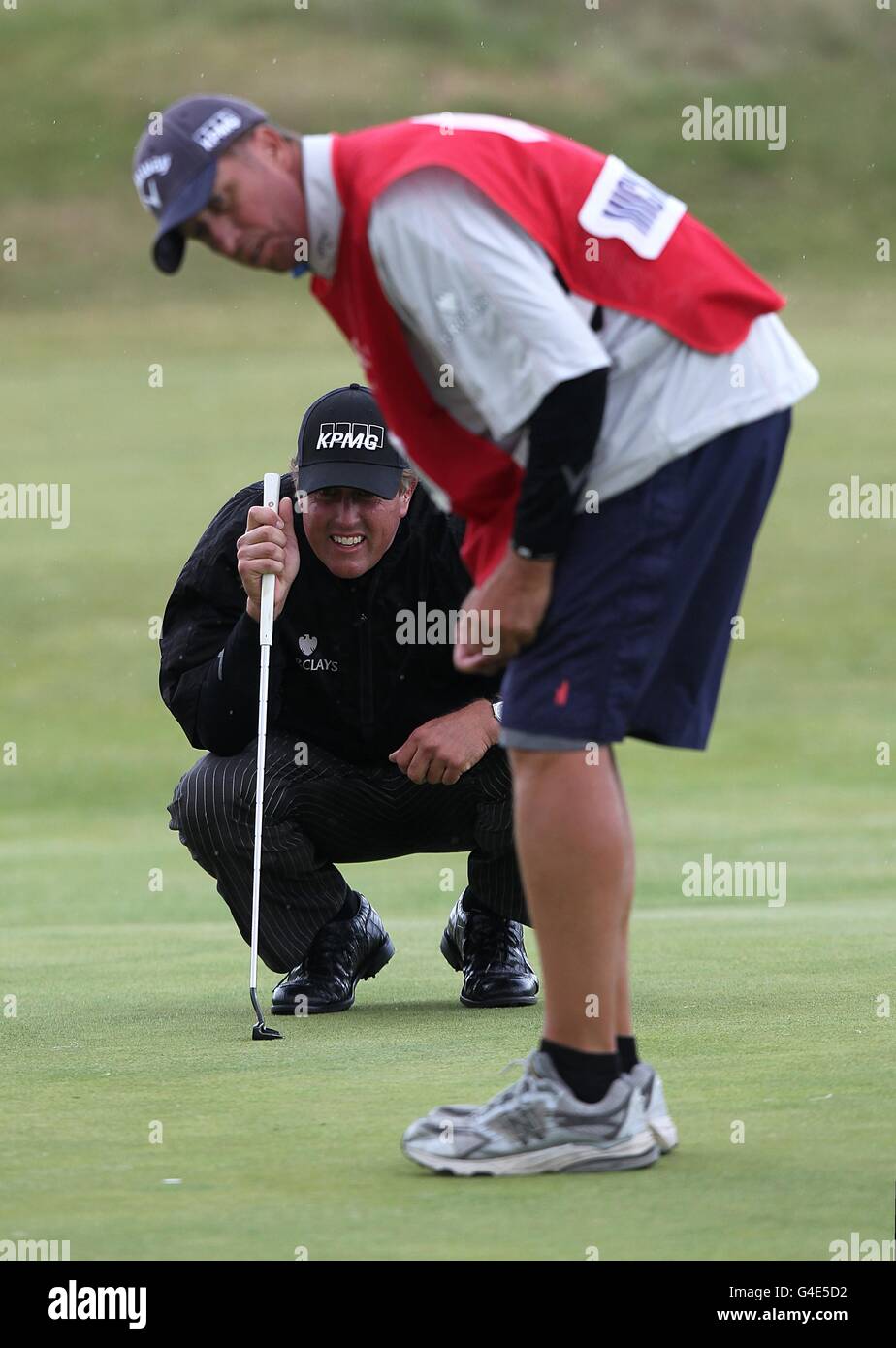 USA's Phil Mickelson (left) and his caddy Jim Mackay line up a putt ...