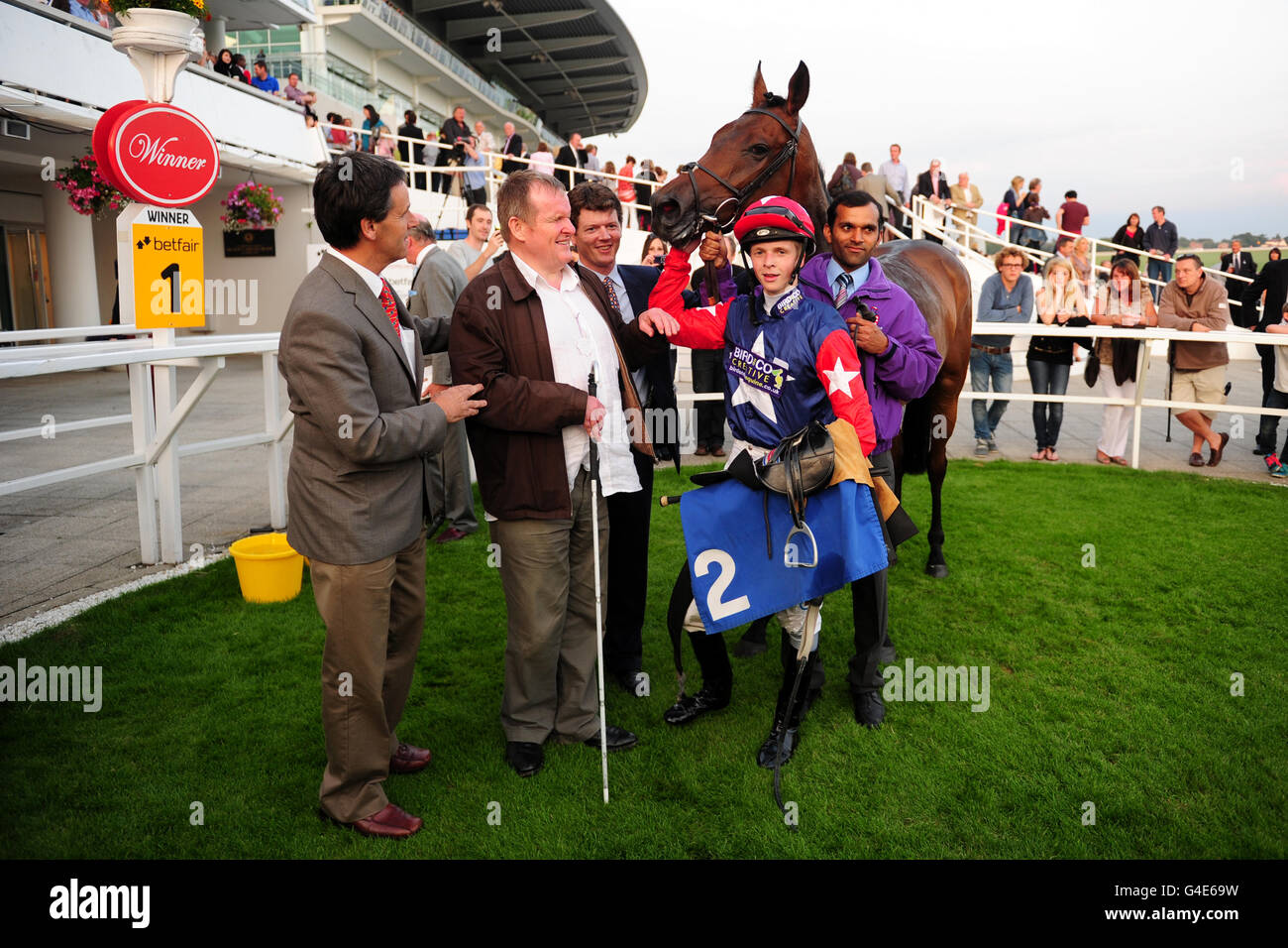 Jockey David Probert (right) and trainer Andrew Balding (third right ...