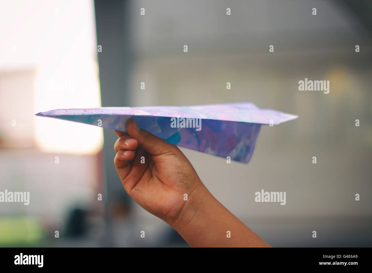 Photograph of a human hand with a paper plane Stock Photo - Alamy