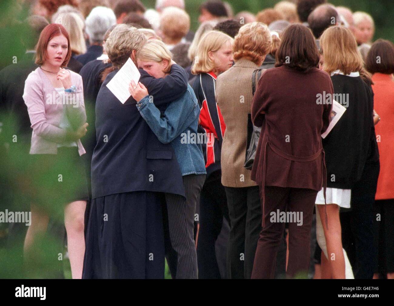 Mourners reacts following the cremation service for school teacher ...