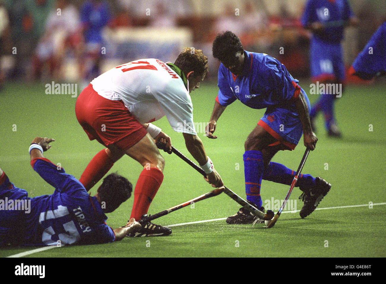 Wales' Richard Markham forces the ball through India's defence during ...