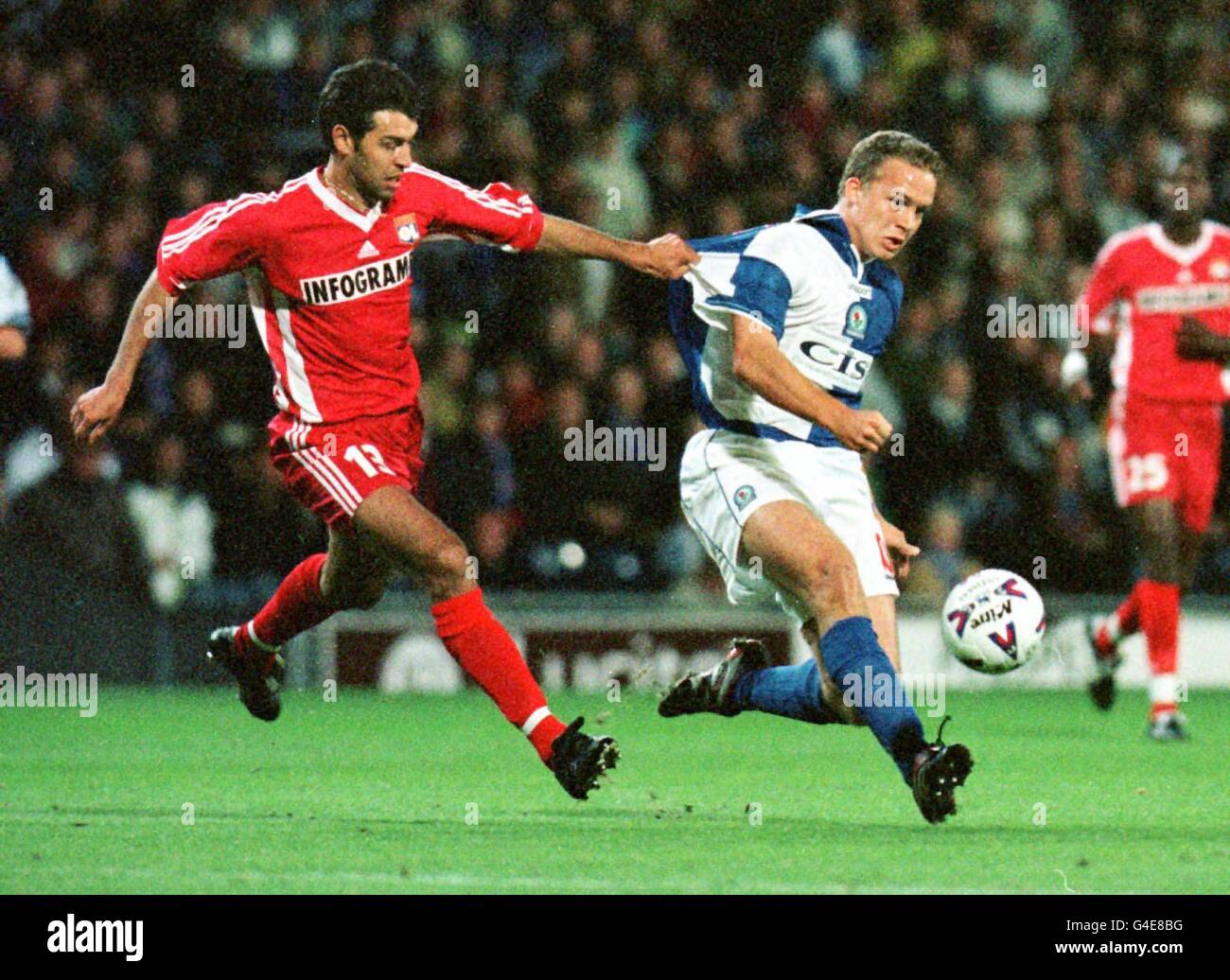 Blackburns Kevin Davies gets a little pull from Lyon's Hubert Fournier ...