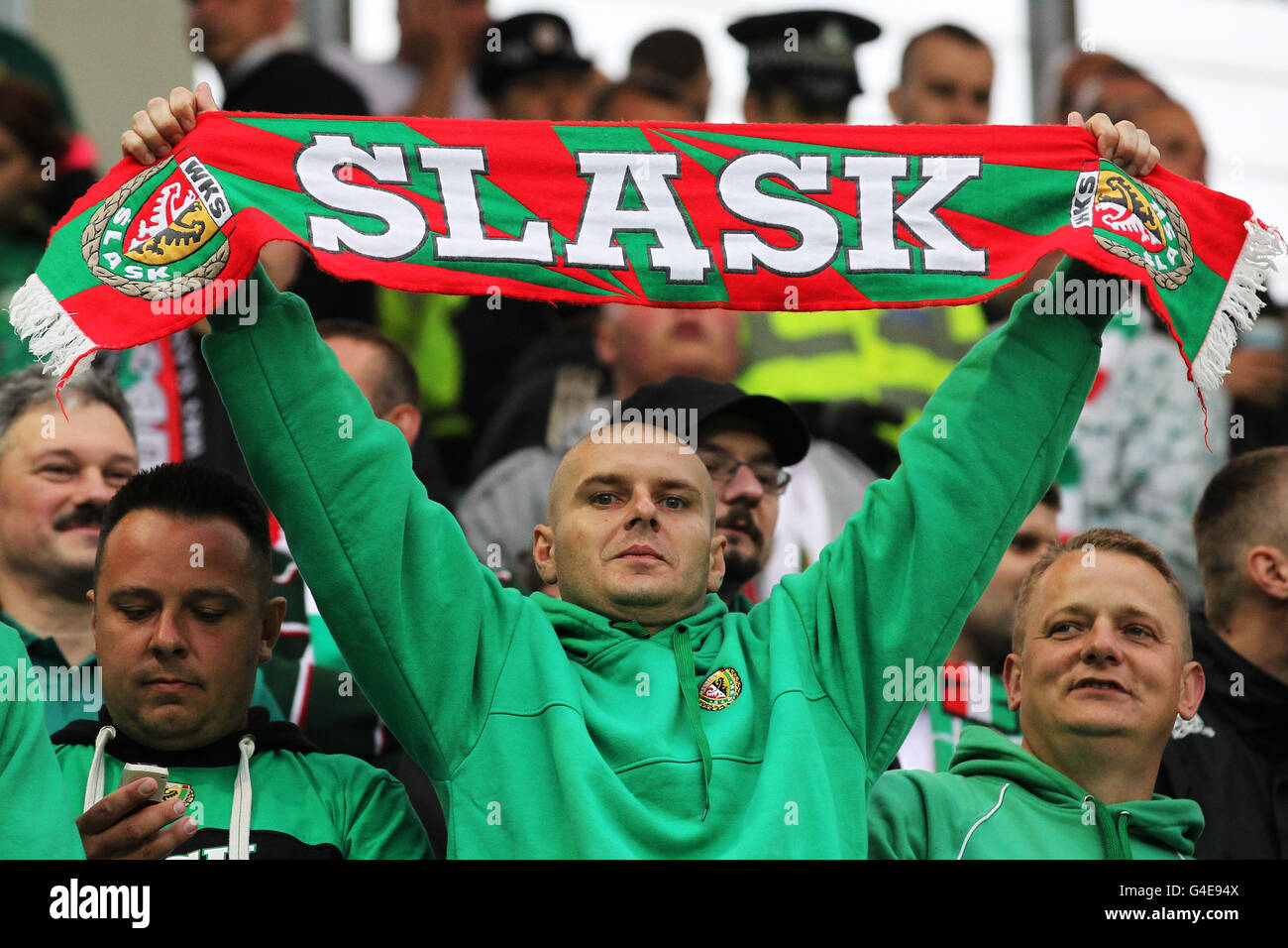 Slask wroclaw fan holds up scarf in the hi-res stock photography and ...