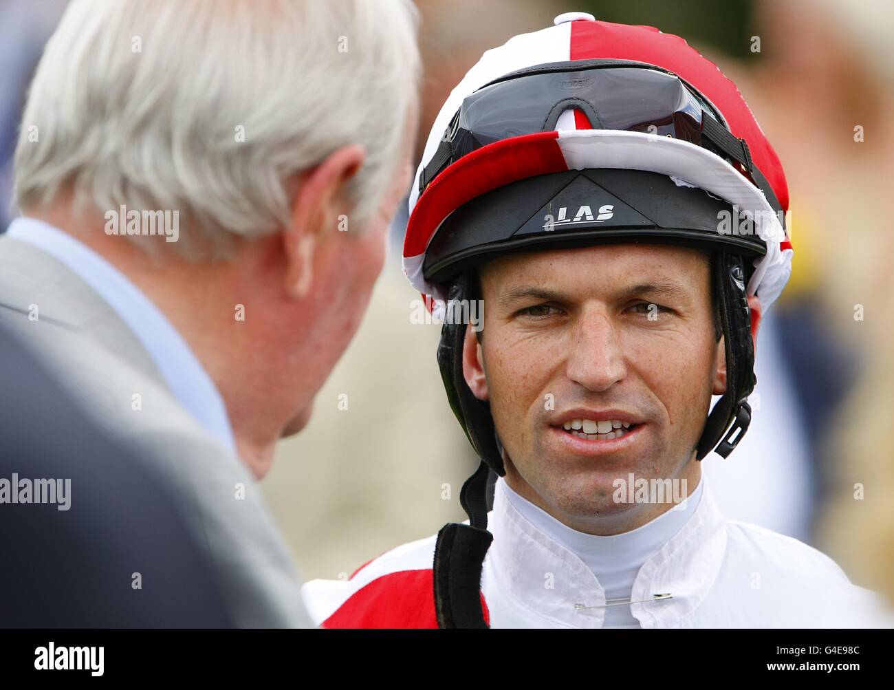 Jockey pat dobbs speaks with trainer richard hannon hi-res stock ...