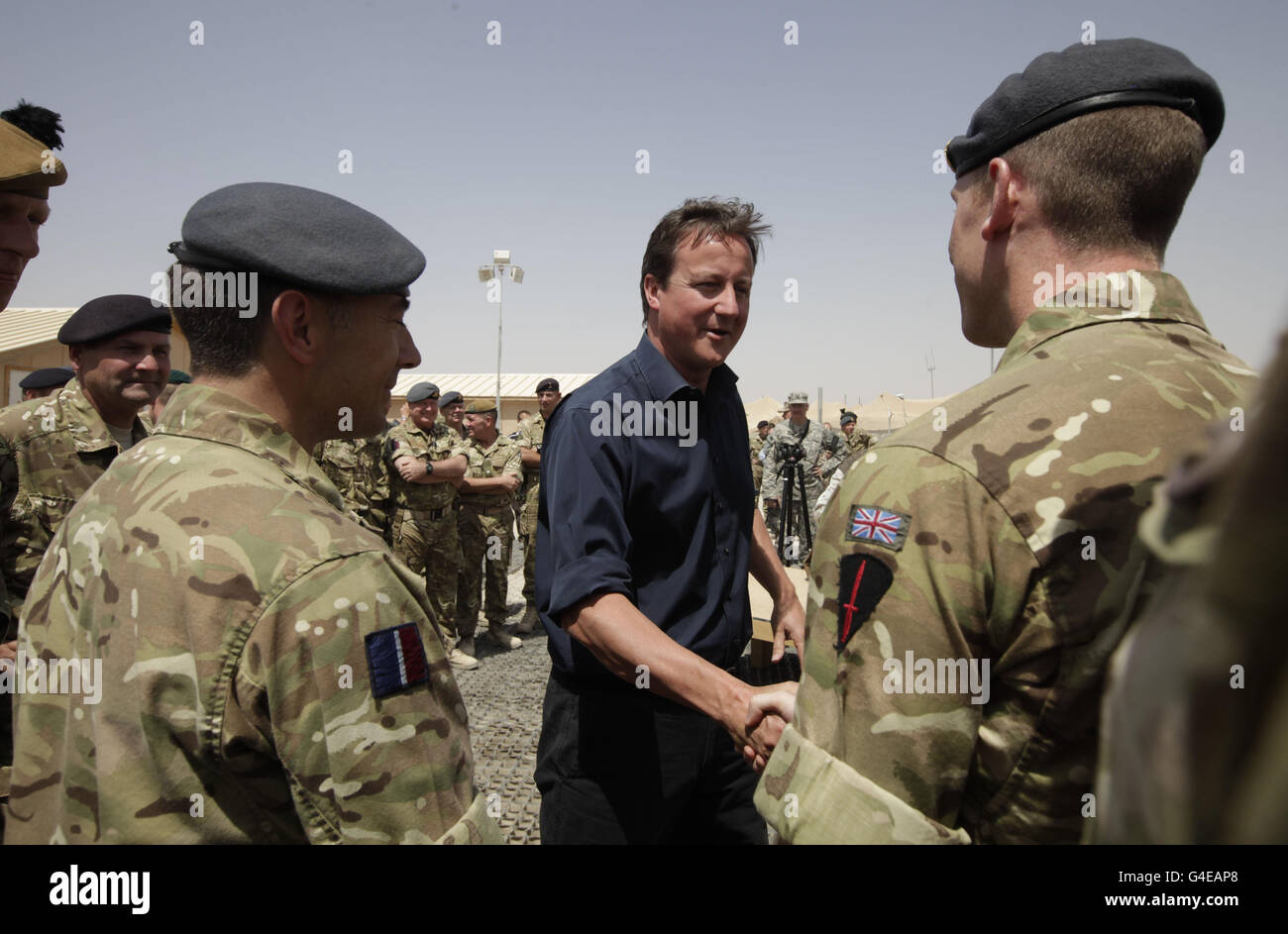 Britain's Prime Minister David Cameron talks to British and US troops ...