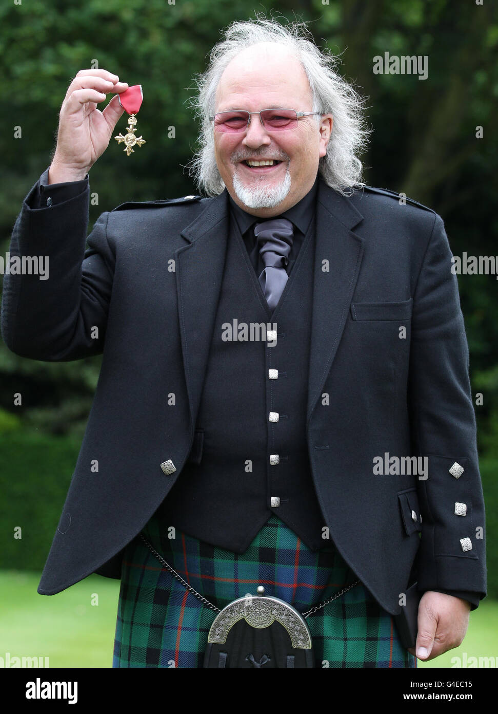 Dr John Lowrie Morrison, who paints under the name Jolomo, with his OBE ...