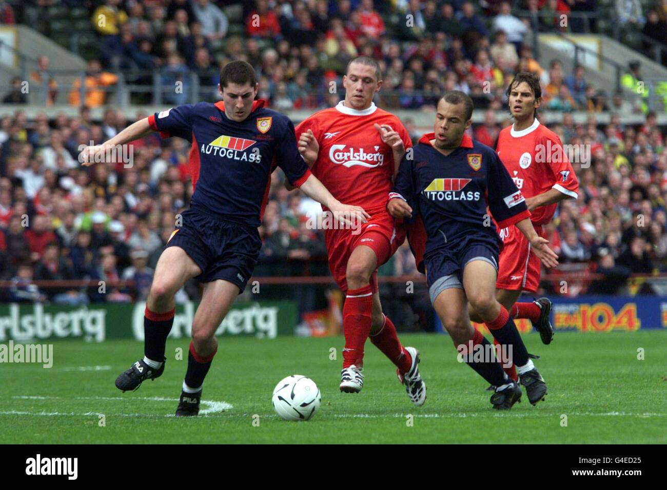 Liverpool's Sean Dundee squeezes between the St Patrick's defence ...