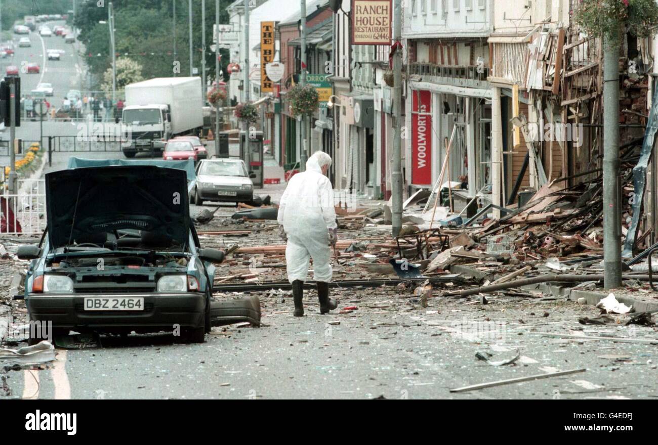 A forensic officer searches through the remains of a building in Newry ...