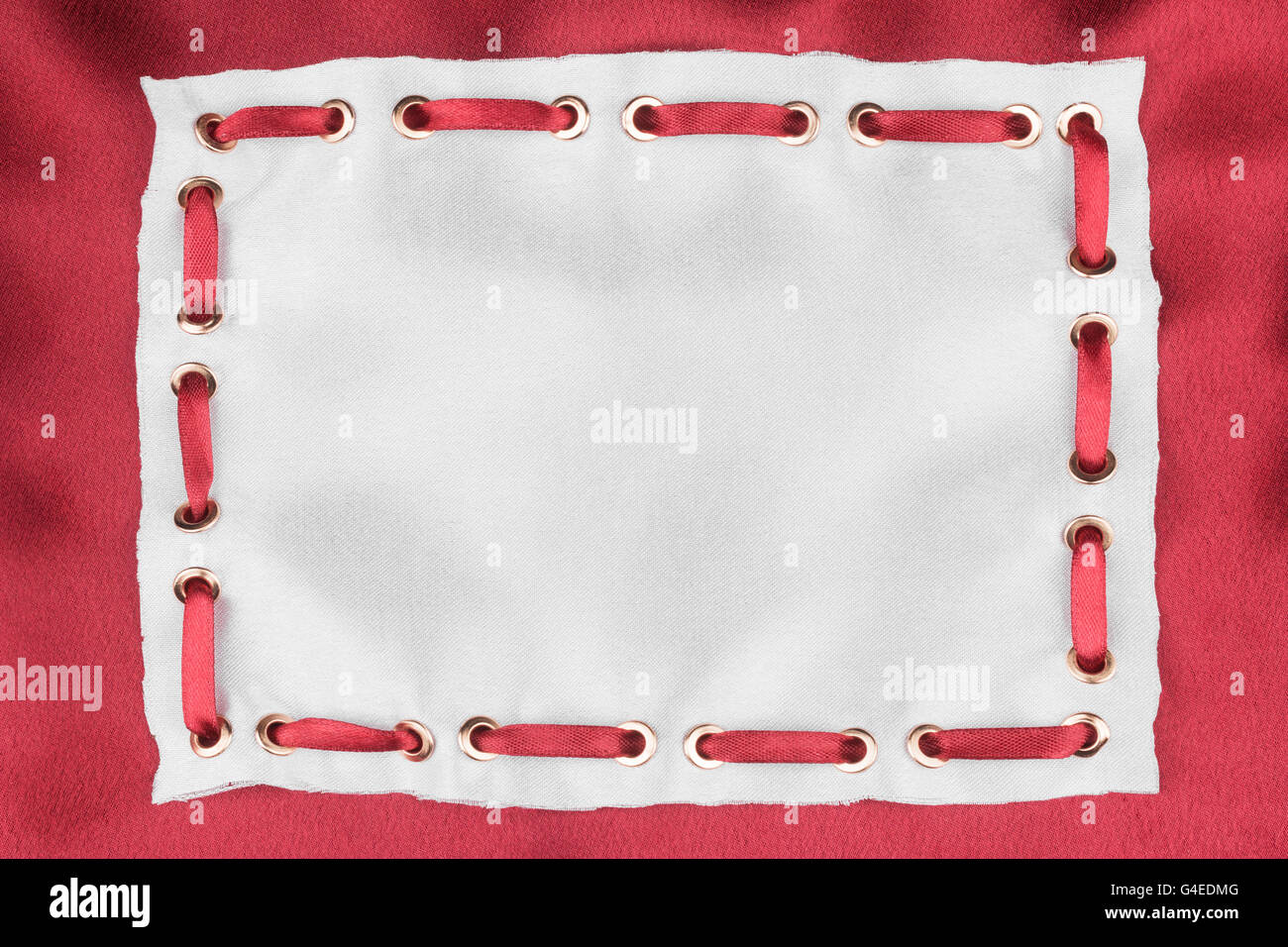 Frame made of white silk with inserted red satin ribbon, on red silk ...