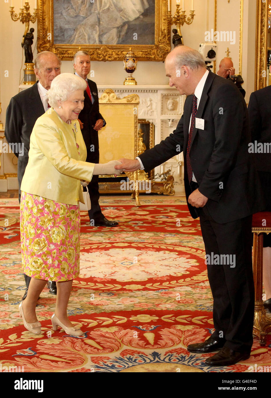Britain's Queen Elizabeth II meets Business Secretary Vince Cable at a ...