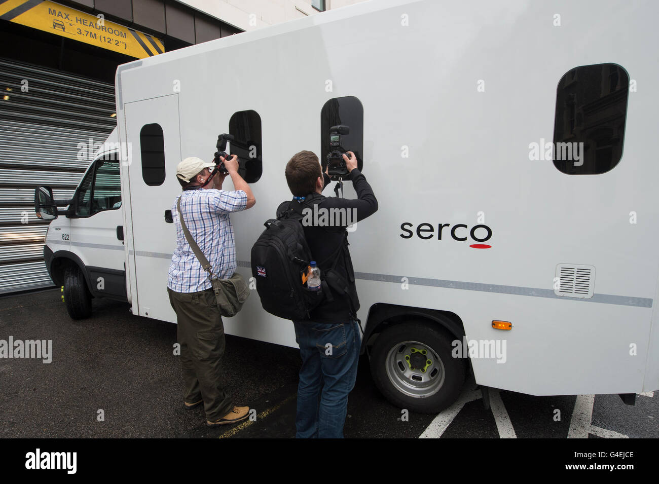Media gather as a Serco van (not believed to be the van carrying Thomas ...