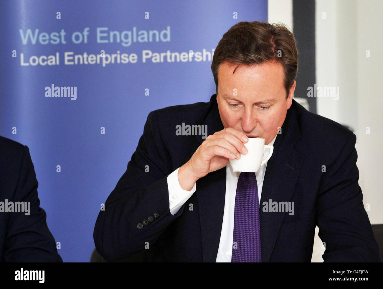 Prime Minister David Cameron sips a drink during a meeting at ...