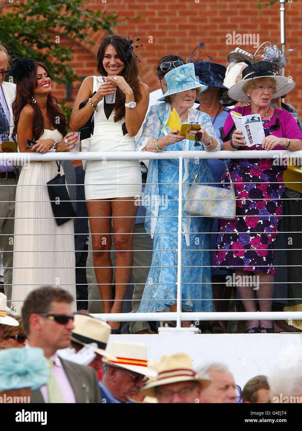 Female racegoers watch the action on Glorious Ladies Day at Goodwood ...