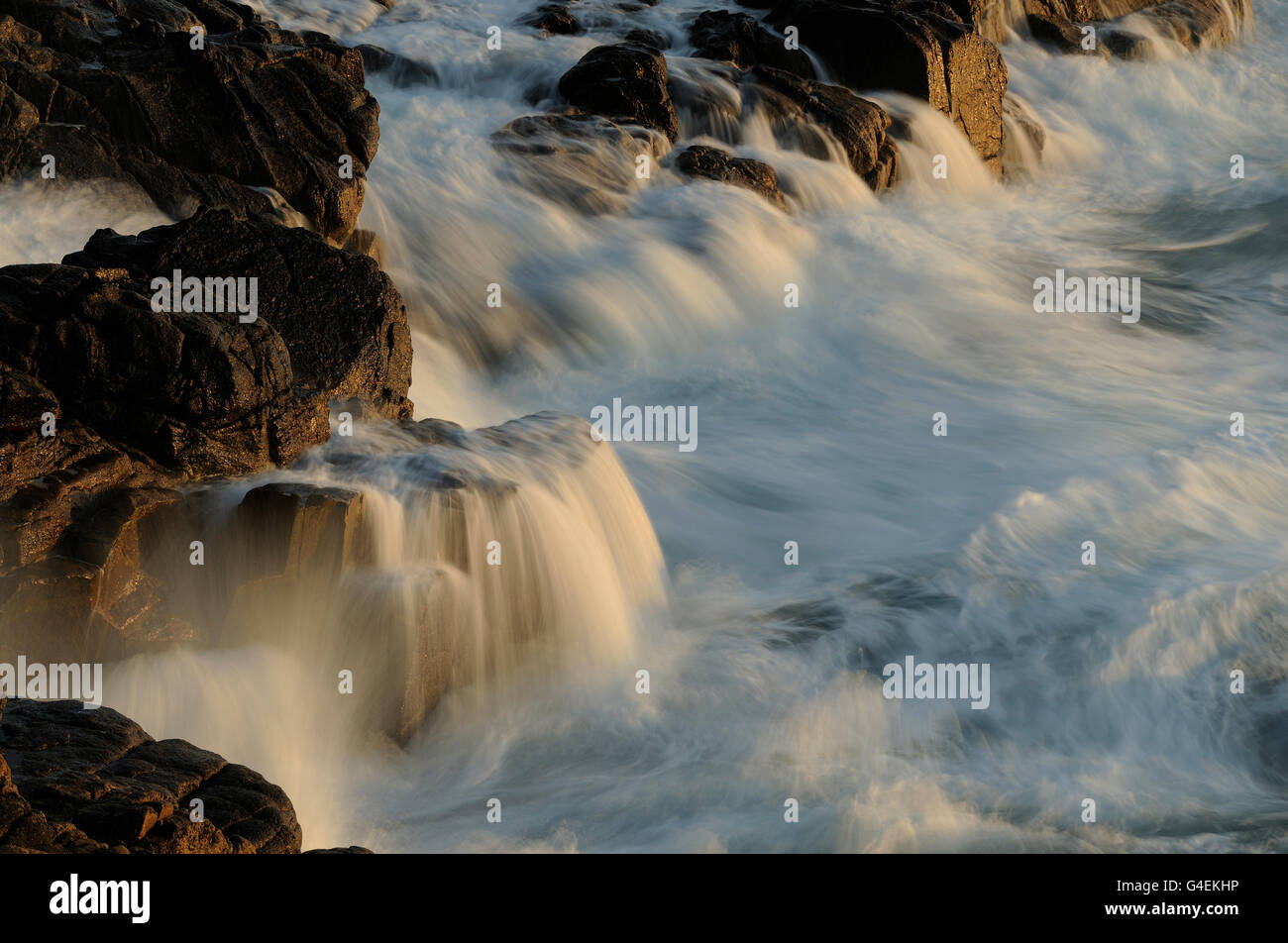 Wave breaking over rocks Cot Valley long exposure creating feathering ...