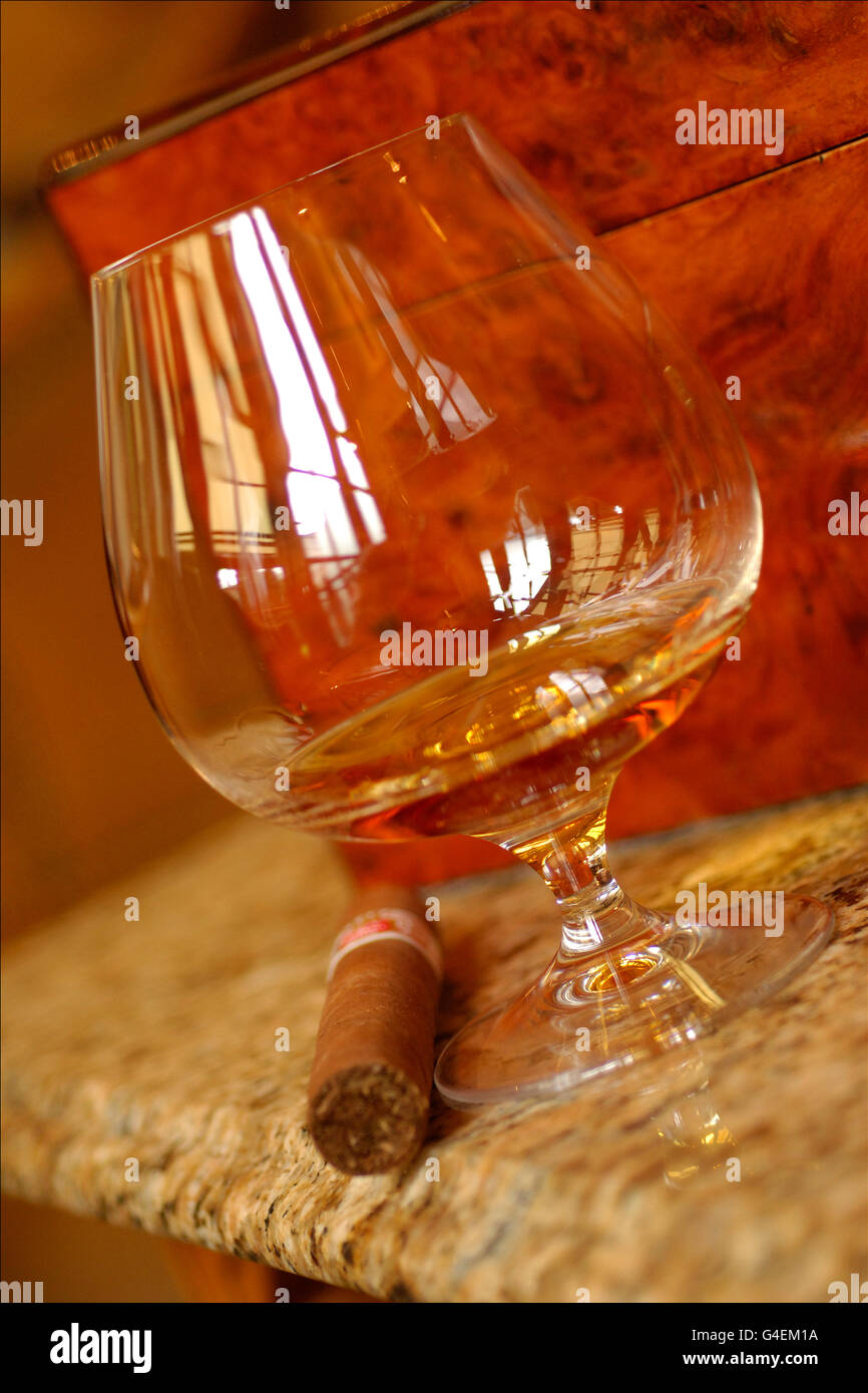 Brandy and Cigar on marble table top with window light reflections ...
