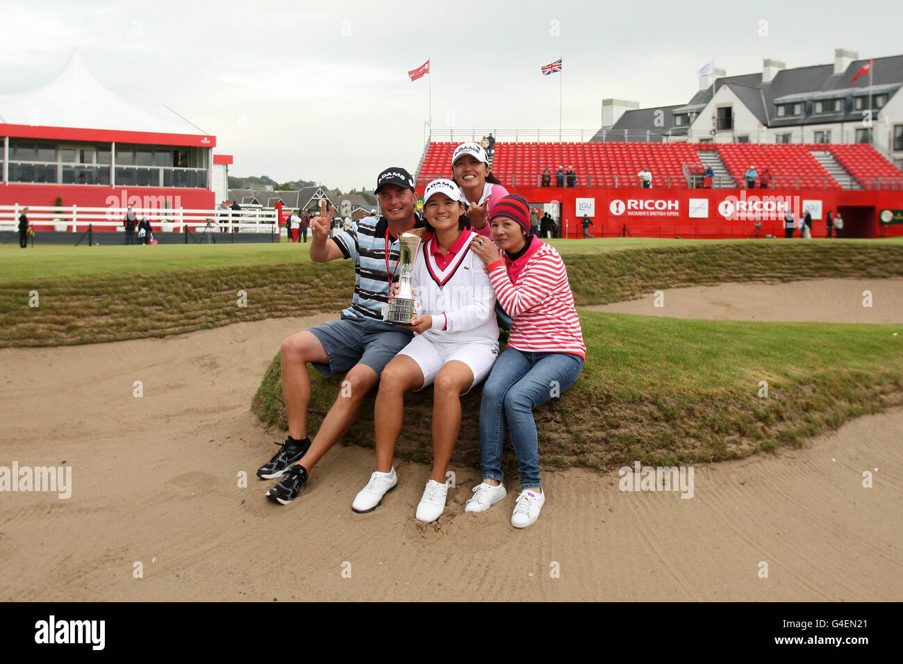 Yani Tseng of Taiwan poses with the trophy and caddie Martin Taylor ...