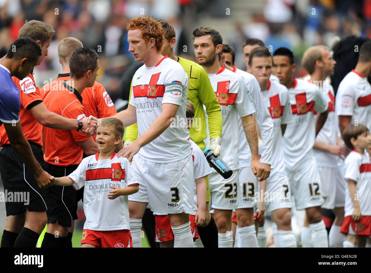 Milton Keynes Dons matchday mascot enjoys the pre-match hand-shake with ...