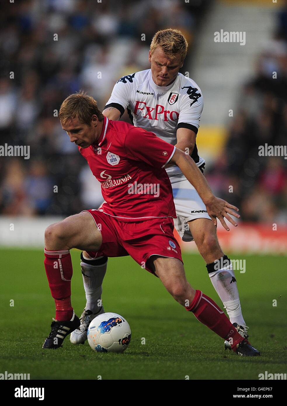 RNK Split's Predrag Simic (left) holds off Fulham's Damien Duff (right ...