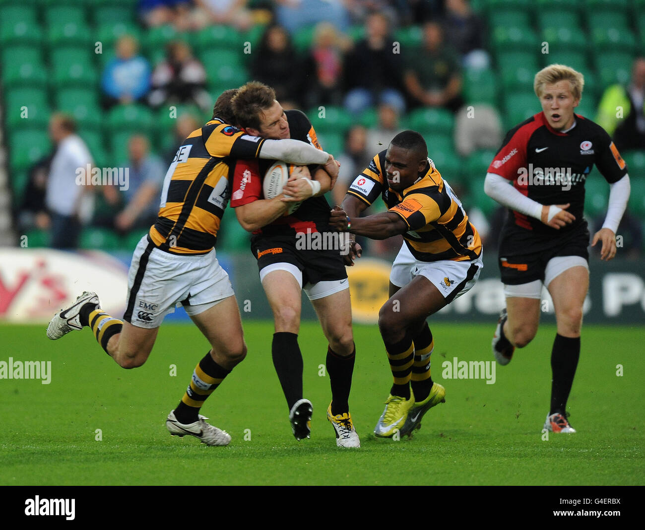 Saracens' Tom Jebb tackled by London Wasps' Joseph Tariperiajua (right ...