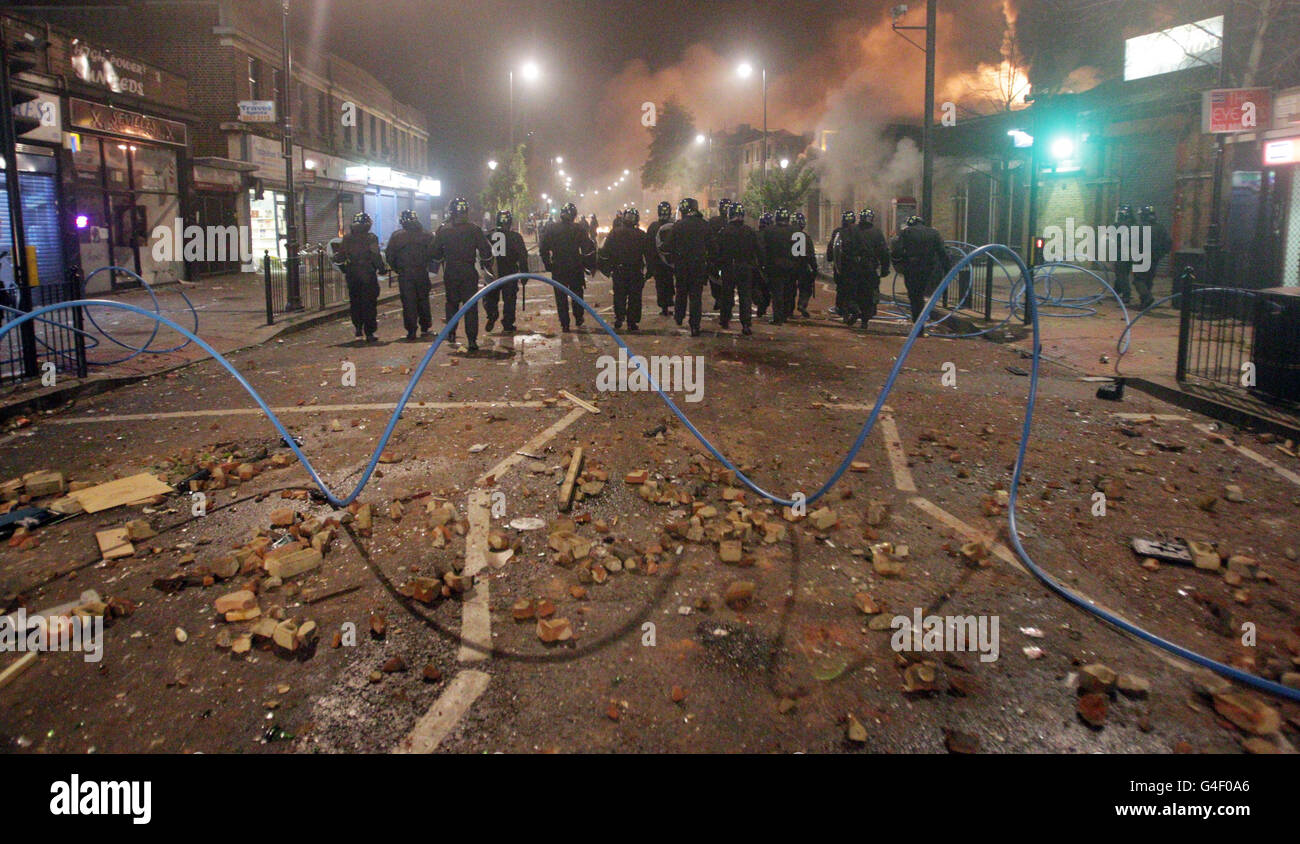 Riot police form a line in Tottenham, north London as trouble flared ...